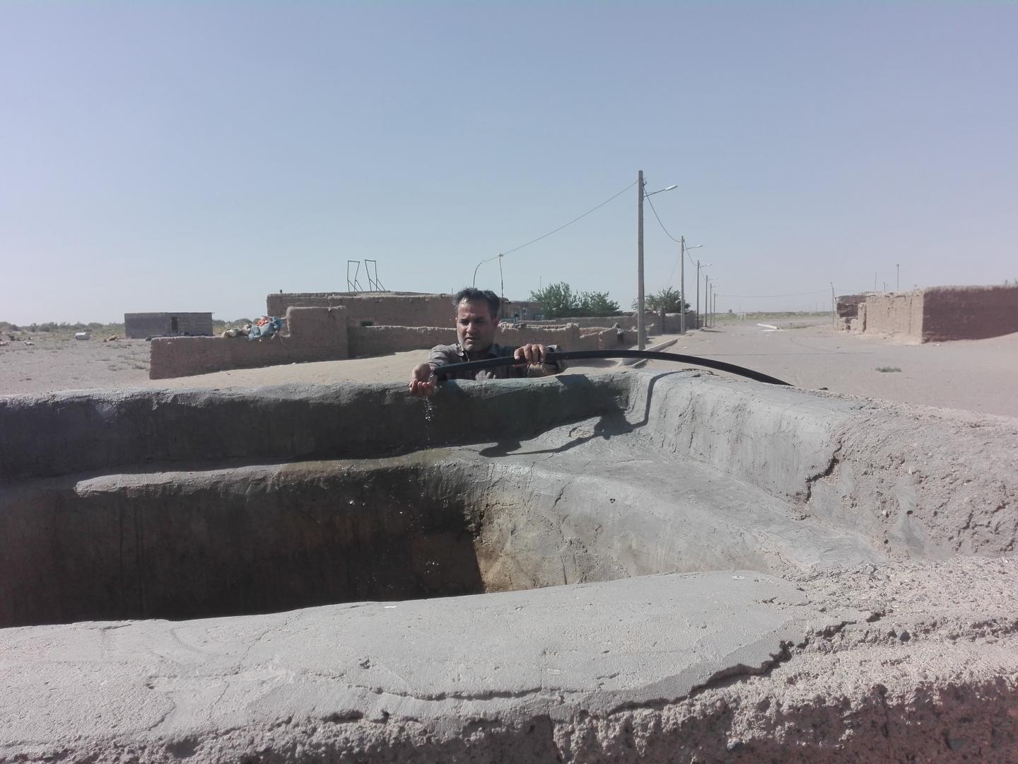 A villager examines water at a [IMAGE] | EurekAlert! Science News Releases