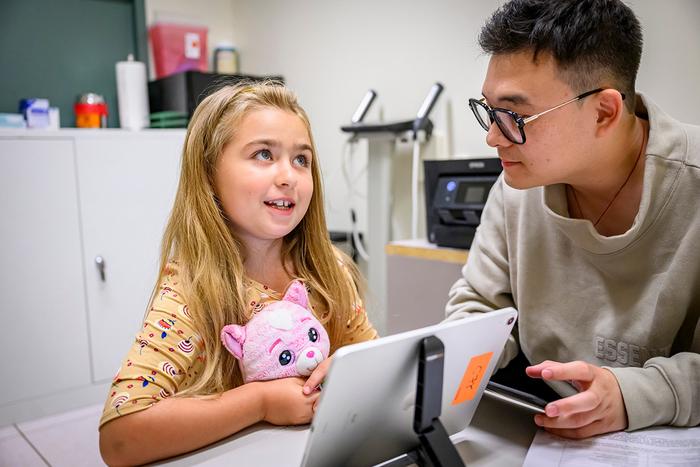 child and researcher [IMAGE] | EurekAlert! Science News Releases