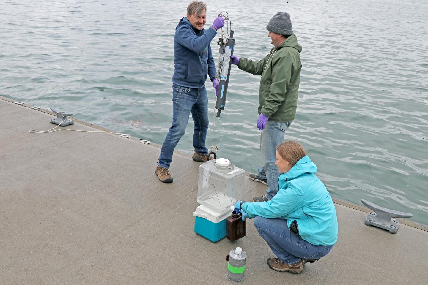 Researchers Sampling from Dock [IMAGE] | EurekAlert! Science News Releases