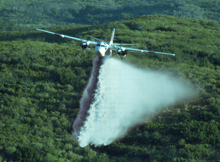 Airplane spraying a forest (co [IMAGE] | EurekAlert! Science News Releases